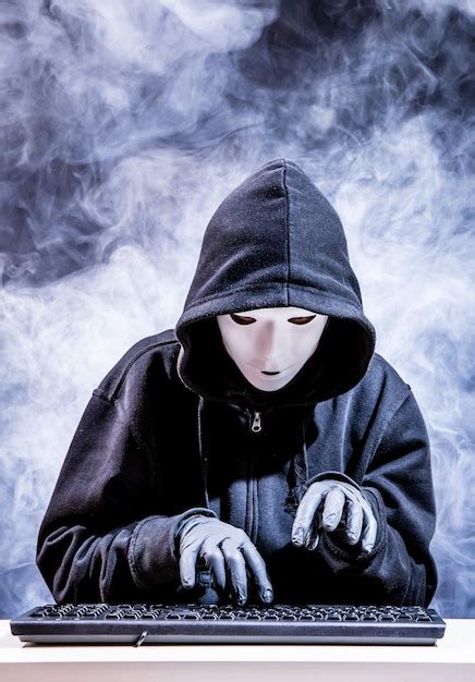 Premium Photo Hacker Typing On Keyboard Amidst Smoke