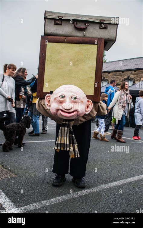 Puppet And Puppeteer With Back Breaking Carrying Of Tea Chest And