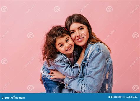 Laughing Mother And Daughter Looking At Camera Front View Of Young