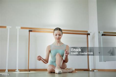 예쁜 부드러운 어린 소녀 발레리나가 바닥에 앉아 뾰족한 신발을 신고 있다 발레 학교 실내에서 훈련 고전 발레 예술 안무의 개념 12 13세에 대한 스톡 사진 및 기타 이미지