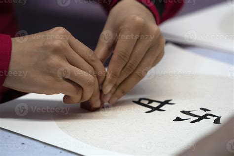 Japanese Woman Writing Name Charles In Ideograms With Brush 20300211