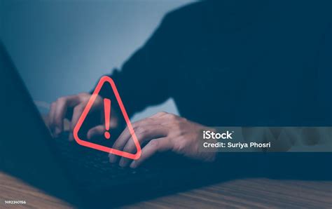 Businessman Using Laptop With Triangle Caution Warning Sing For Notification Error And