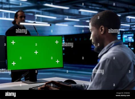 Employee Using Green Screen PC To Check For Signs Of Imminent Failure