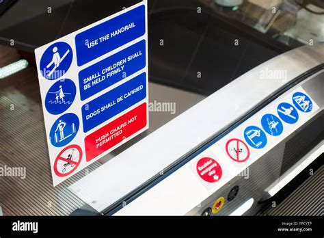 Escalator Safety Sign Symbols Close Up And Text On Glass At Top Of