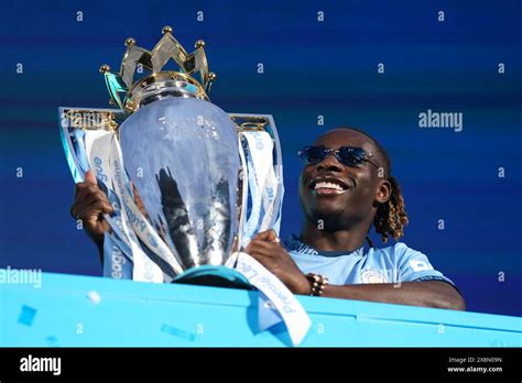 Jeremy Doku Lifts The Premier League Trophy During A Trophy Parade In