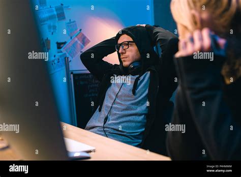 Female Hacker Looking At Depressed Accomplice At Workplace Stock Photo Alamy