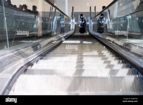 Female Using Escalator To Go Up To Next Floor Stock Photo Alamy