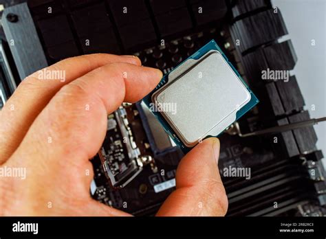 Technician Is Carefully Inserting CPU Into Motherboard Socket During A Desktop Computer Assembly