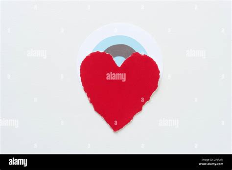 Red Paper Heart With Torn Edge On Various Paper Rings On Blank Paper