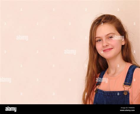Blue Eyed Brown Haired Shy Girl In Denim Overalls Studio Model Shot