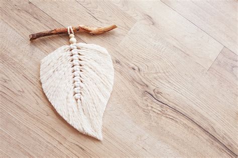 Premium Photo Macrame Leaf In Natural Color And Thread Windings Lying On A Wooden Table