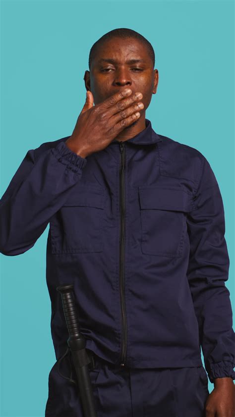 Vertical Tired Security Guard Yawning While Being Tasked With Preventing Criminal Activity And