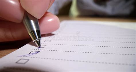 Closeup Of Hand Putting Checkmark Or Marking With Blue Pen On Checklist And Checkbox And To Do