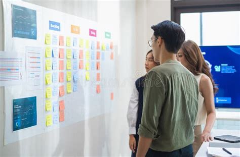 Brainstorming Session Using Sticky Notes On A Task Board Kanban To Organize Ideas And