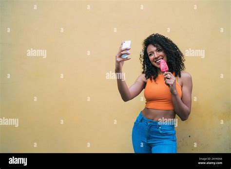 Portrait Of Afro Woman Taking Selfies With Her Mophile Phone While