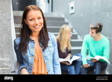 Happy Female Collage Student With Two Collage Student Friends Sitting