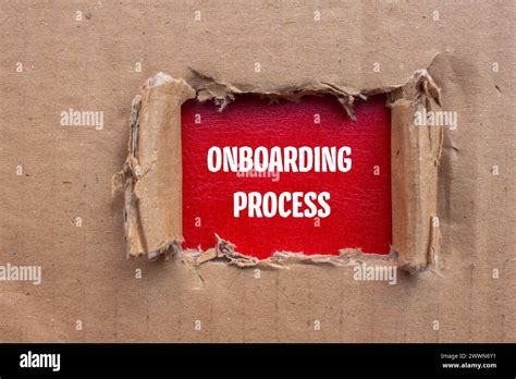 Onboarding Process Words Written On Torn Cardboard Paper With Red