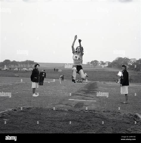 1960s Historical An Adult Female Athlete In Mid Air Doing The Long