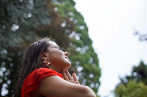 A Woman Prays While Being Drenched In Rain Stock Photo Image Of