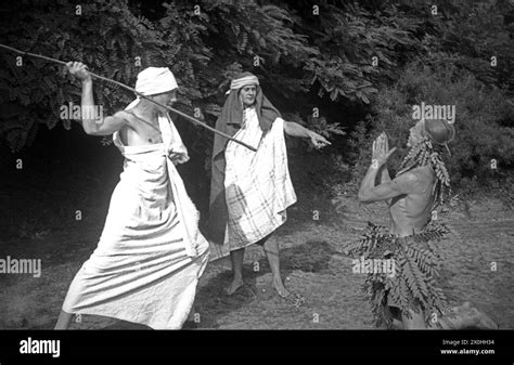 Three Young Men In Disguise Performing A Play On The Edge Of A Forest