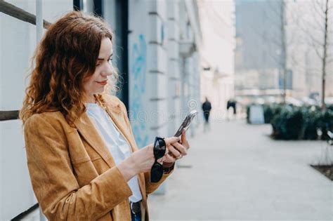 Young Woman Engaging With Ai Powered Mobile Tools In An Urban