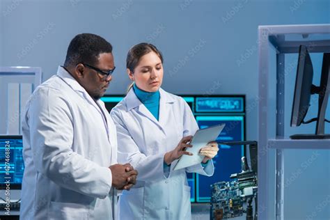 Diverse Team Of Microelectronic Engineers Discuss Current Developments
