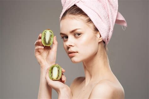Premium Photo Beautiful Woman Naked Shoulders Spa Treatments Kiwi In Hands Natural Cosmetics