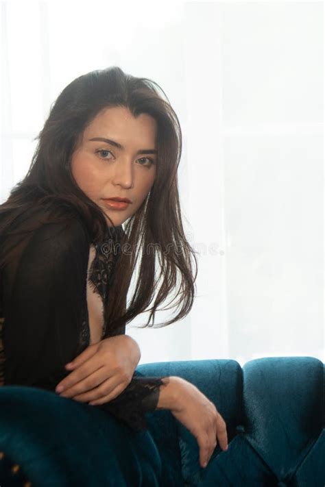 Sensual Dresses Asian Women Sensuality Arm On The Blue Sofa Stock