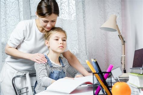 Premium Photo Mother Helping Daughter In Homework