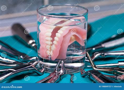 Artificial Teeth In A Cup With Dental Instruments Stock Image Image
