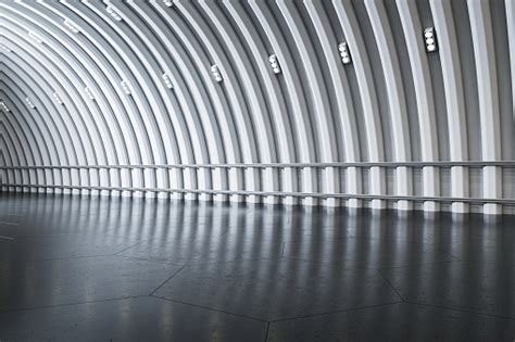 텅 빈 짙은 회색 광택 바닥이 있는 추상적인 넓은 공간에 대한 투시도 조명이 켜진 아치형 슬레이트 천장 배경에 자동차 또는 제품 프레젠테이션을 위한 장소 3d 렌더링 모형