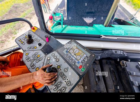 Worker Operator Is Controlling Tarmac Road Laying Machine With