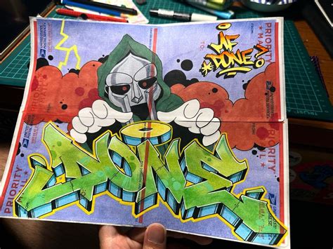 Someone Holding Up A Book With Graffiti On It