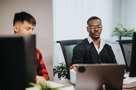 Diverse Business Team Working At Office Desks Analyzing Documents And