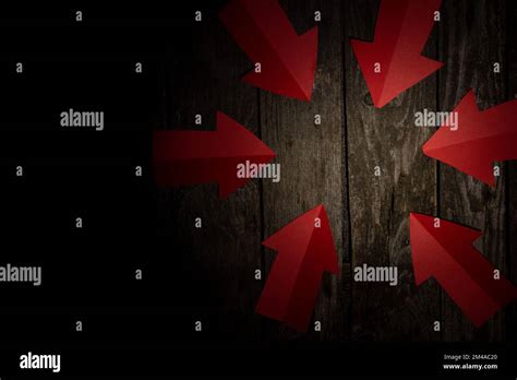 paper arrows pointing to the center of the table on a dark background