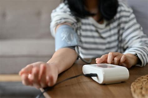Premium Photo An Asian Female Checking Her Blood Pressure And Heart Rate With Blood Pressure