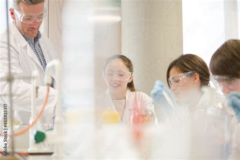 Male Teacher And Babes Conducting Scientific Experiment In Laboratory Classroom Stock Photo