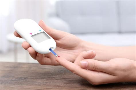 Premium Photo Woman Testing Glucose Level With Digital Glucometer Indoors