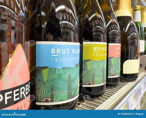 Selection Of Sparkling Wine Bottles On Store Shelf With Diverse Labels