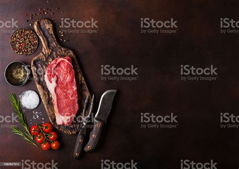 칼과 녹슨 배경에 포크와 오래 된 빈티지도 마 보드의 원시 등심 쇠고기 스테이크 소금과 신선한 로즈마리와 토마토와 고추 텍스트를 위한 공간 갈비 음식에 대한 스톡 사진 및