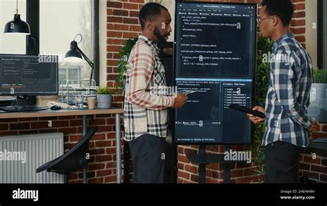 team of software engineers leaving after analyzing source code on wall