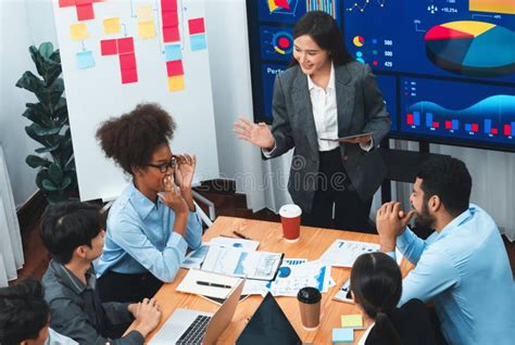 Young Asian Businesswoman Presenting Data Analysis Dashboard On Tv