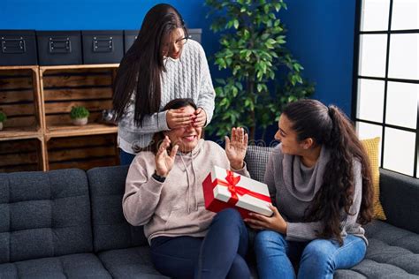Three Woman Surprise With T Sitting On Sofa At Home Stock Image