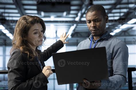 Computer Scientists In Data Center Automating Routine Maintenance Tasks With Laptop Executing