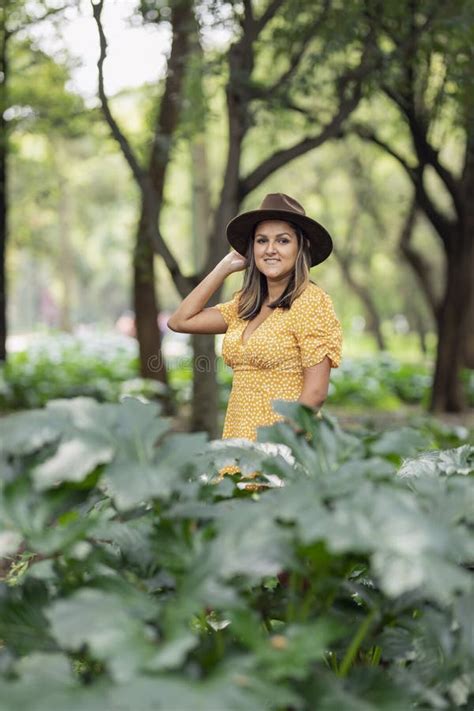 Portrait A Young Happy Latin Woman With Yellow Dress And Hat Stock