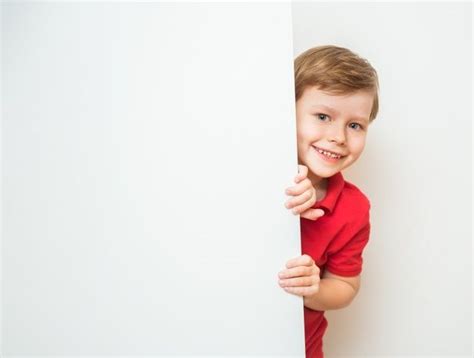 Счастливый ребенок мальчик выглядывает из за белого знамени Премиум Фото Счастливый ребенок