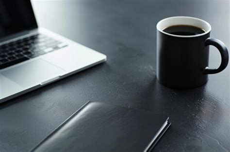 Modern Office Desk With A Laptop Notepad And Coffee Mug On A Black Surface Copy Space Premium