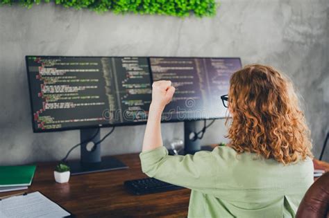 Rear Portrait Of Young Hacker Programmer Girl Raise Fist Computer Display Wear Shirt Workstation