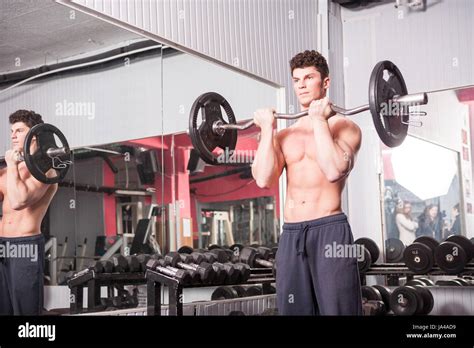 Exercising In The Gym With Heavy Weights Lifting Heavy Weights
