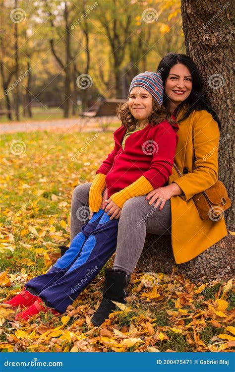 Cheerful Mother And Son Sitting Near Tree Stock Image Image Of Female